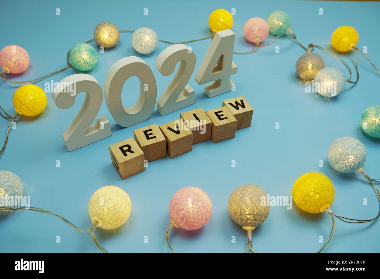 Review 2024 letters with LED cotton balls decoration on blue background ...