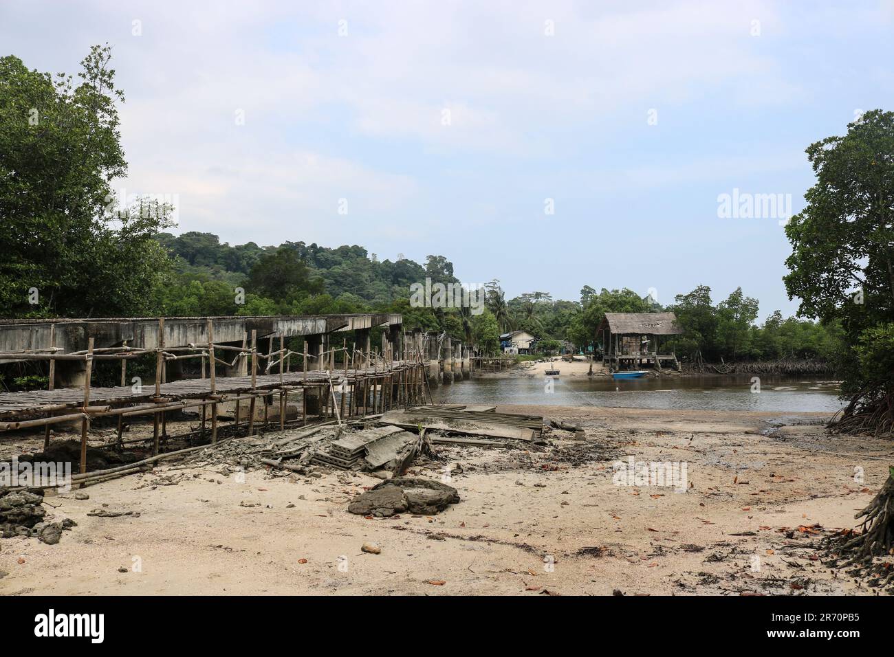 Destroyed concrete and bamboo bridge across the river to the Aboriginal ...