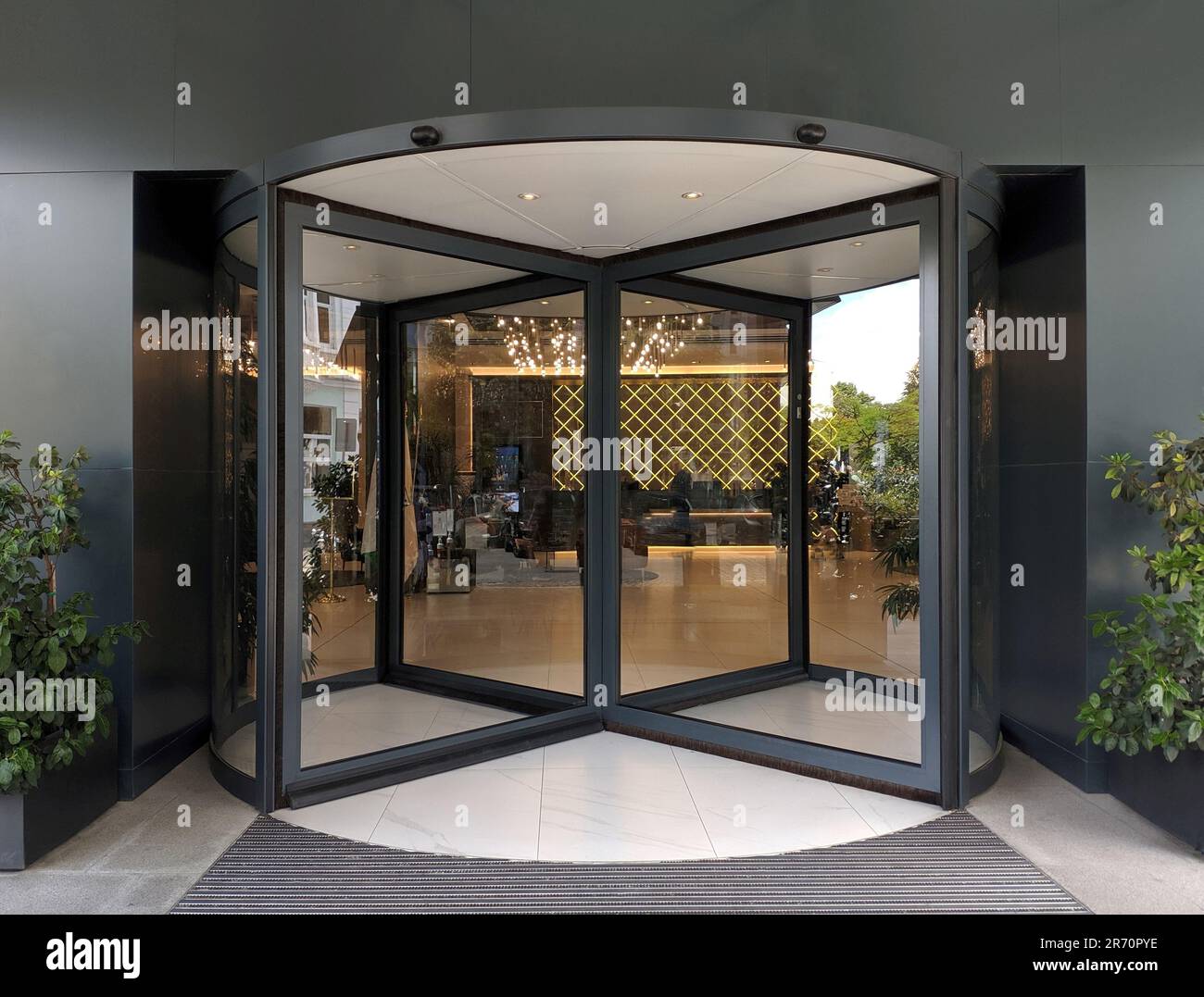 Automatic modern black rotating doors office mockup Stock Photo - Alamy