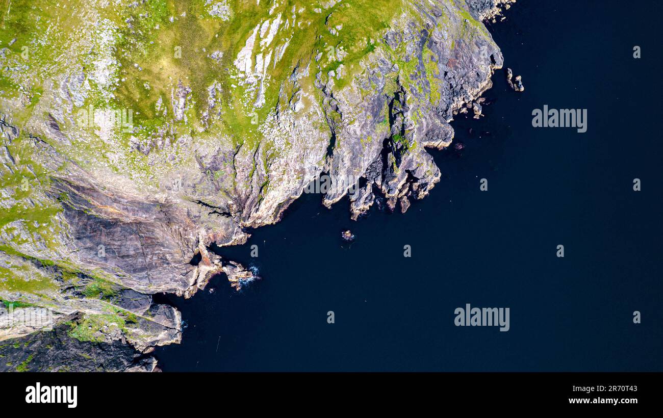 Ulster 2022. An aerial view of a high cliff dropping into the sea at ...