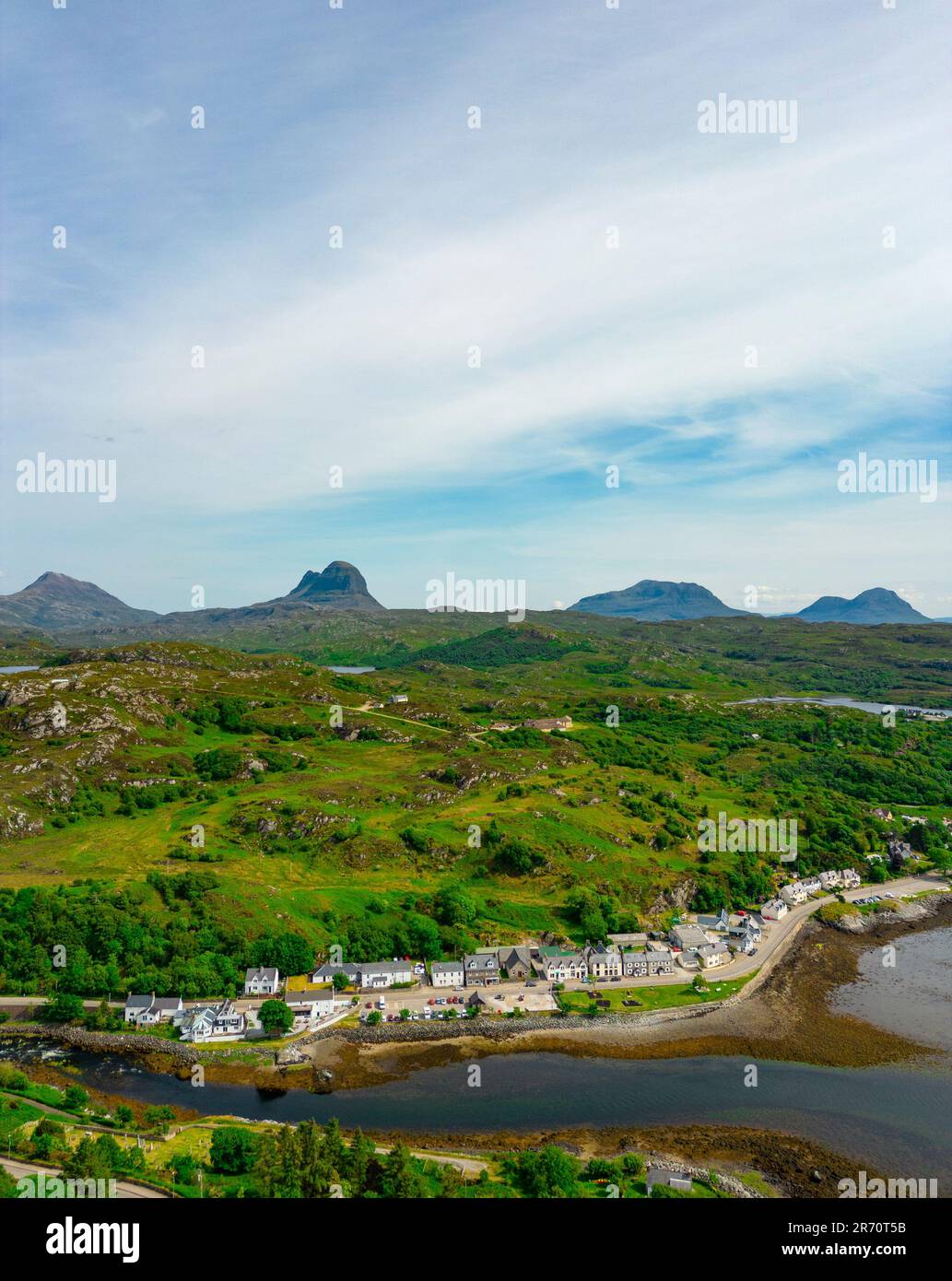 Aerial view of village of Lochinver with mountains of Assynt/Coigach in ...