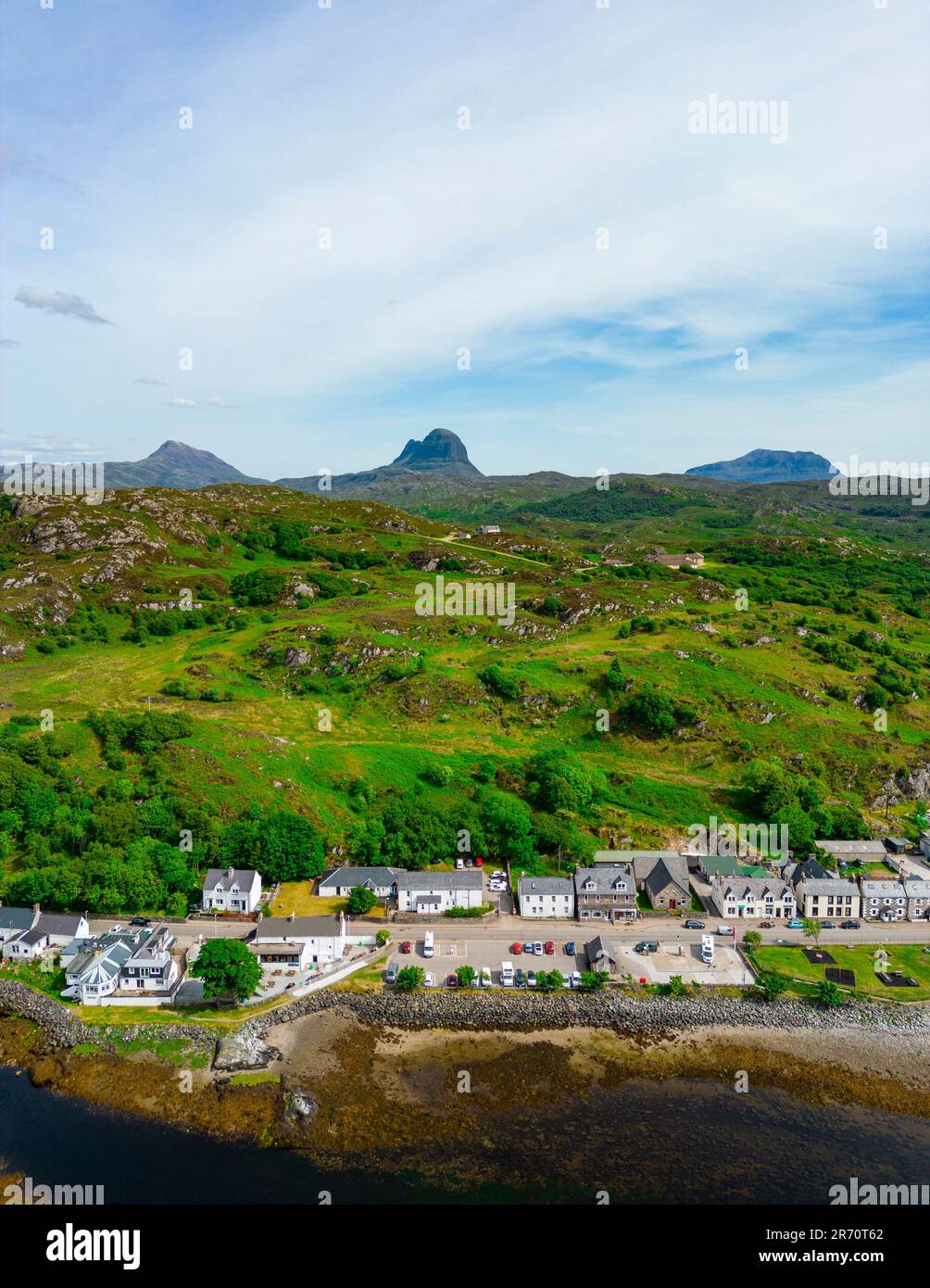 Aerial view of village of Lochinver with mountains of Assynt/Coigach in ...