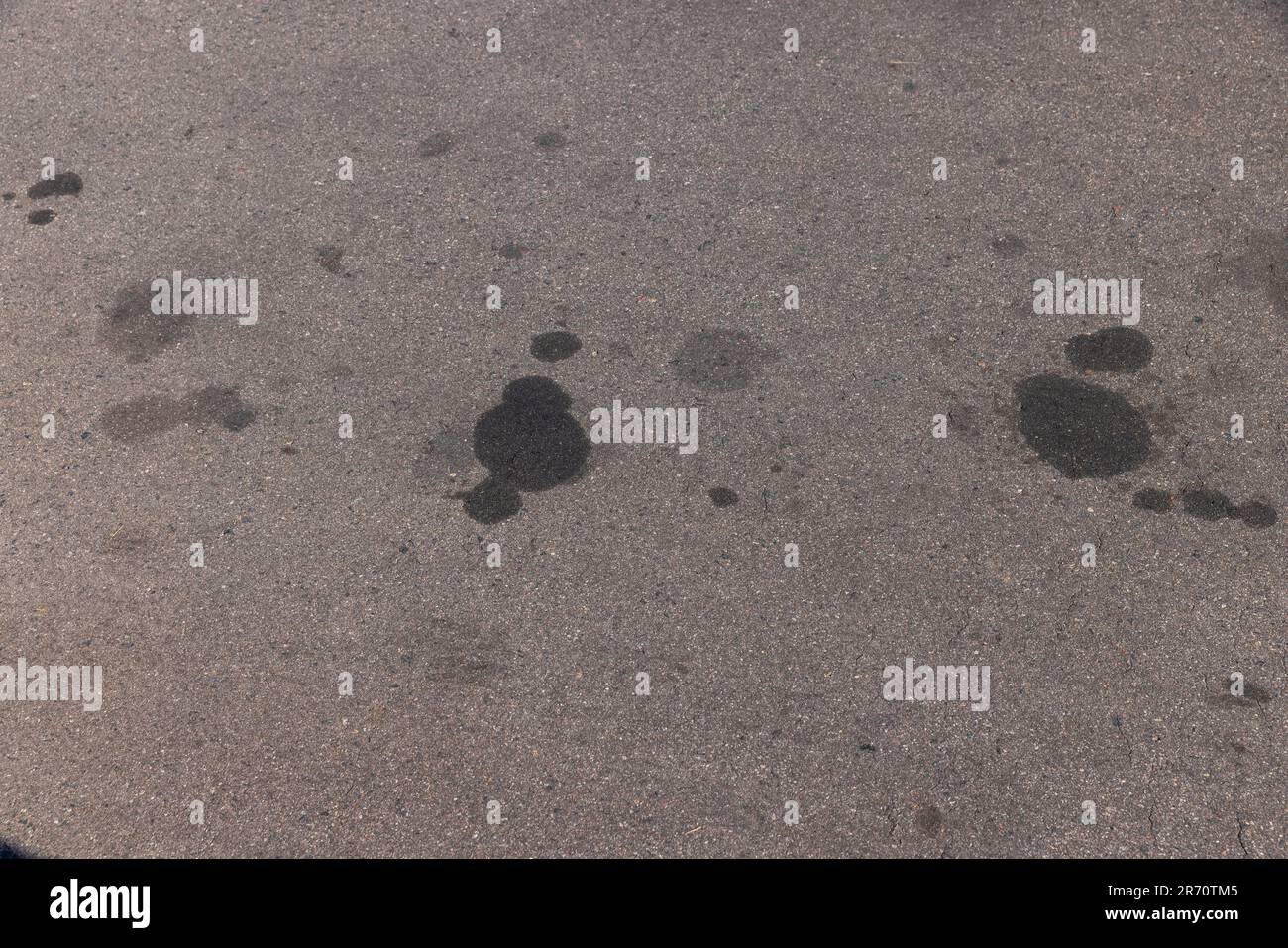 Paved road with engine oil stains and other pollution from cars, part ...