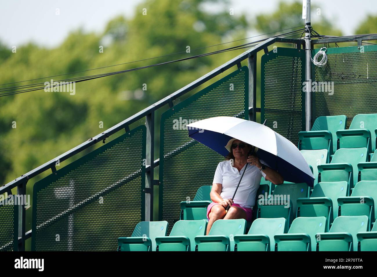 A general view of a spectator sheltering from the sun during day one of ...