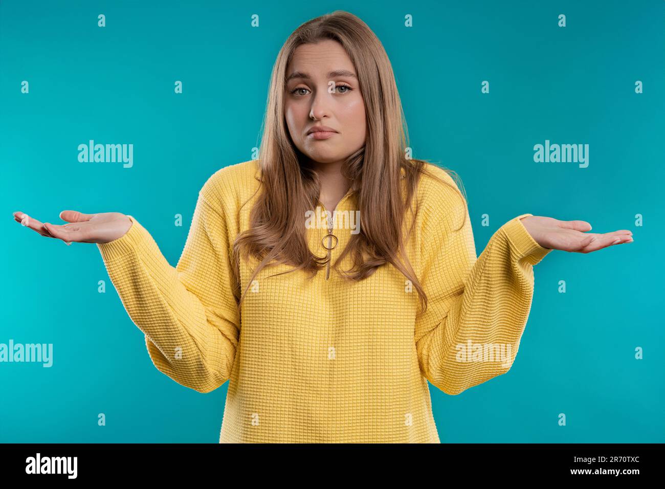 Confused pretty woman, shoulders up - can't help, makes gesture of I ...