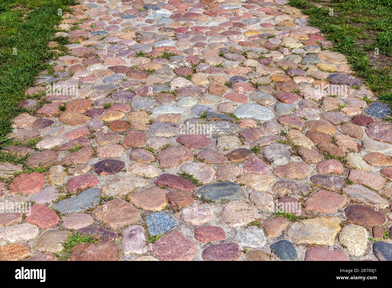 Details of the road made of multicolored stones and cobblestones, part ...