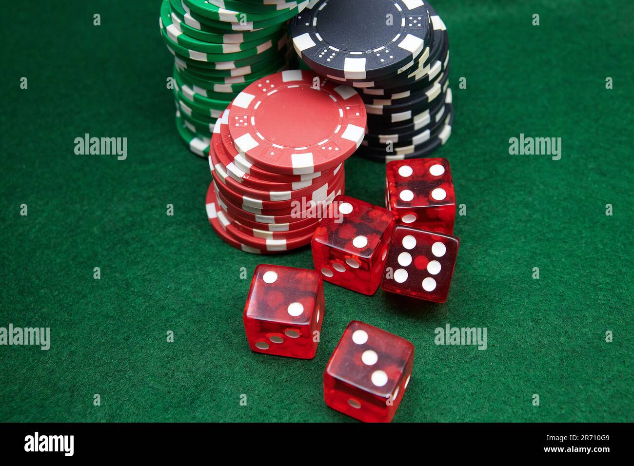 Red Dice and Gambling tokens (Chips) on a green baize table top Stock ...
