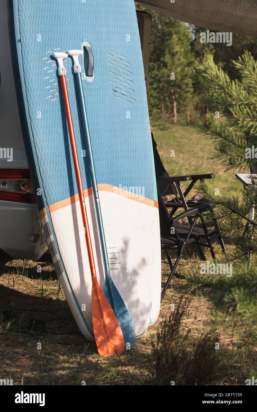 Inflatable Sup rowing boards stand near the motorhome inflated in ...