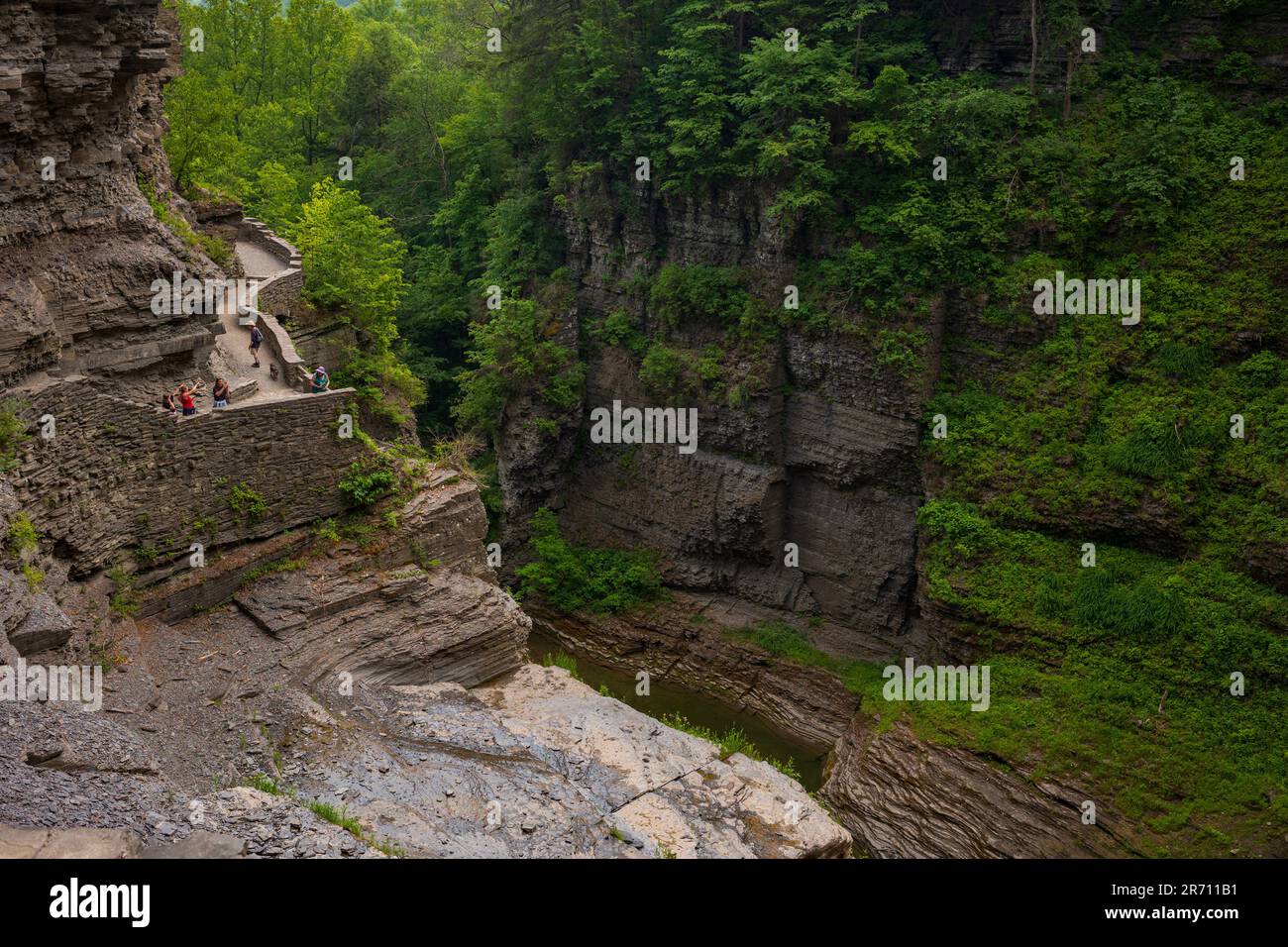 Hikers explore the gorge at Lucifer Falls located at Robert H. Treman ...