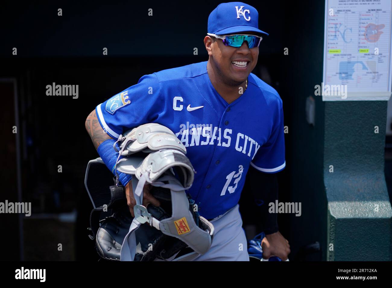 Kansas City Royals catcher Salvador Perez smiles as he walks to the ...