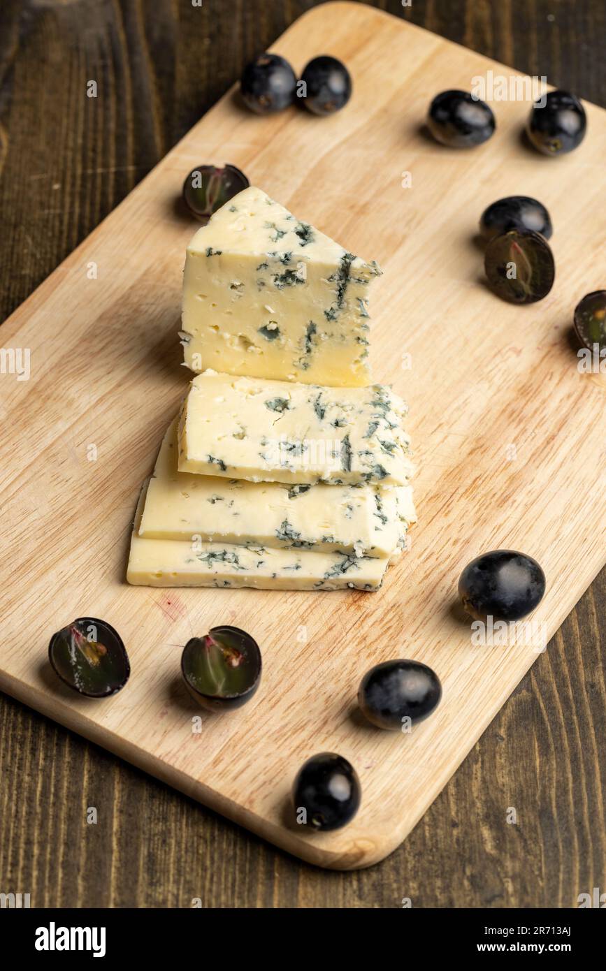 Cheese with blue mold cut into pieces, slices of cheese with blue noble ...