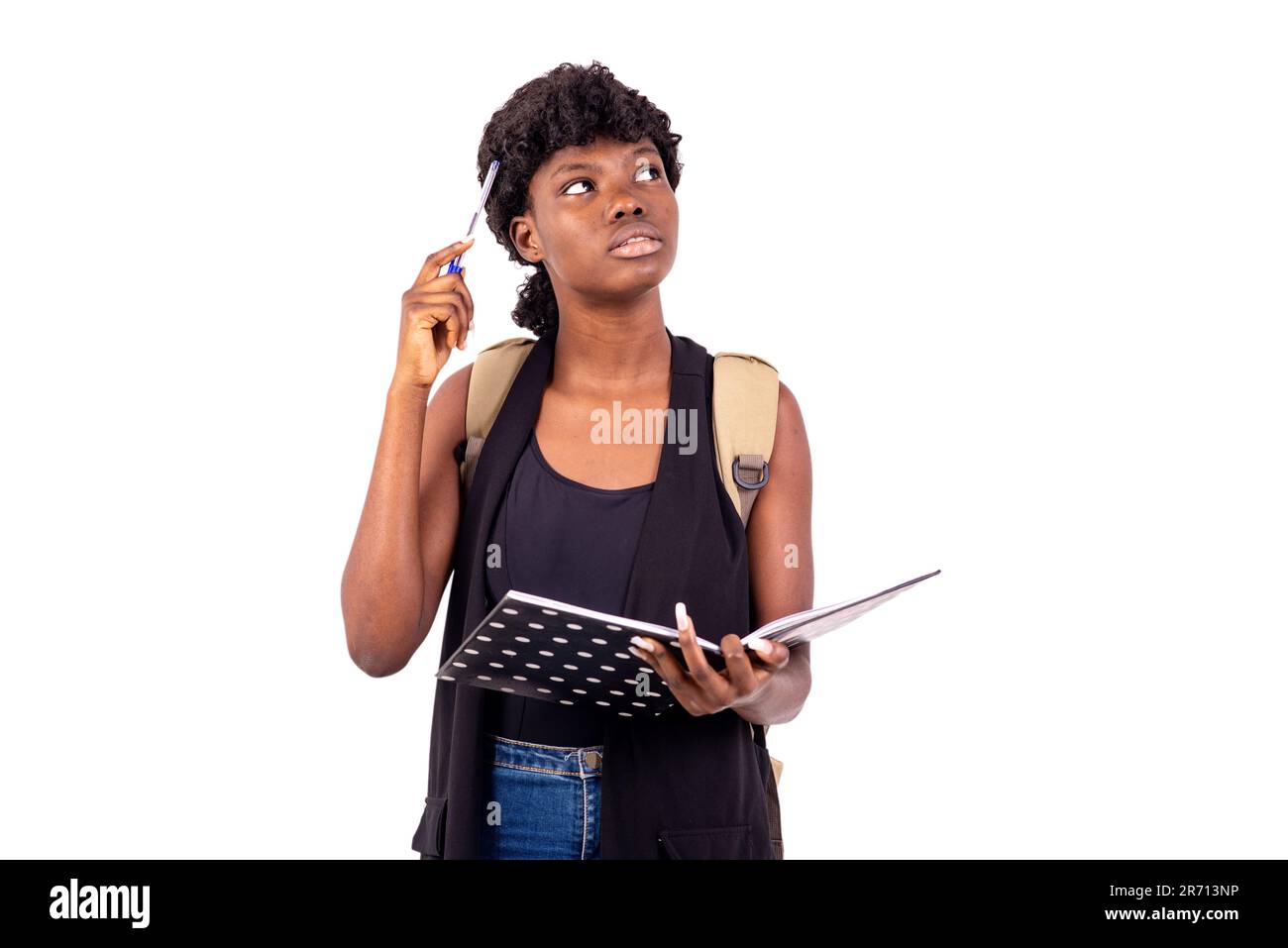 young student girl carrying backpack and thinking about what to write ...