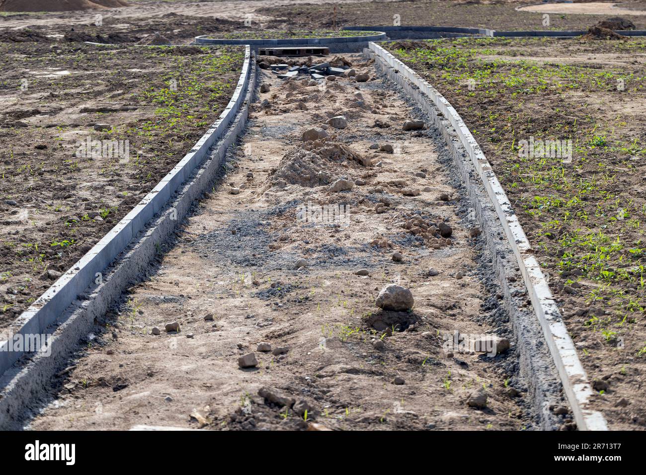 Construction of a new walkway in the park, installed curbs in the ...