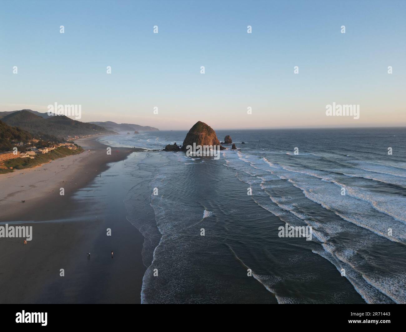 A picturesque view of Haystack Rock in Cannon Beach, Oregon Stock Photo ...