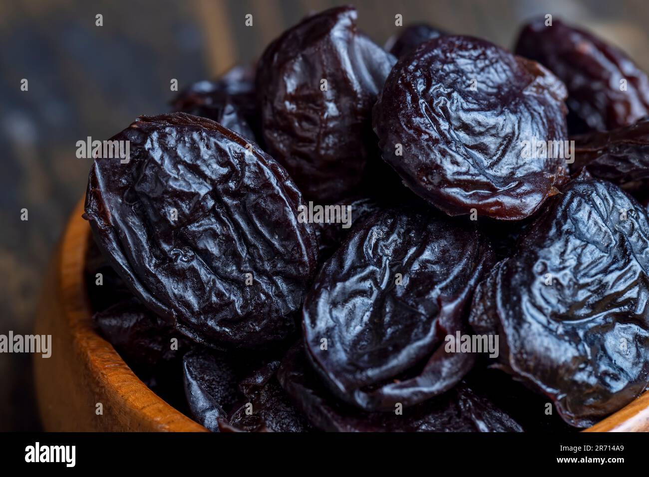 Dried plums on the kitchen table, dried sweet pitted prunes Stock Photo ...