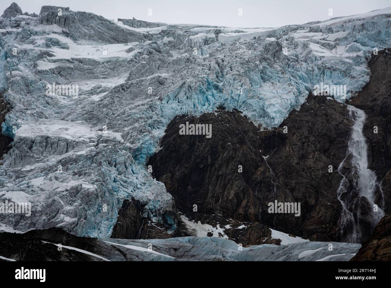 This stock photo depicts a close-up shot of a glacier slowly moving ...