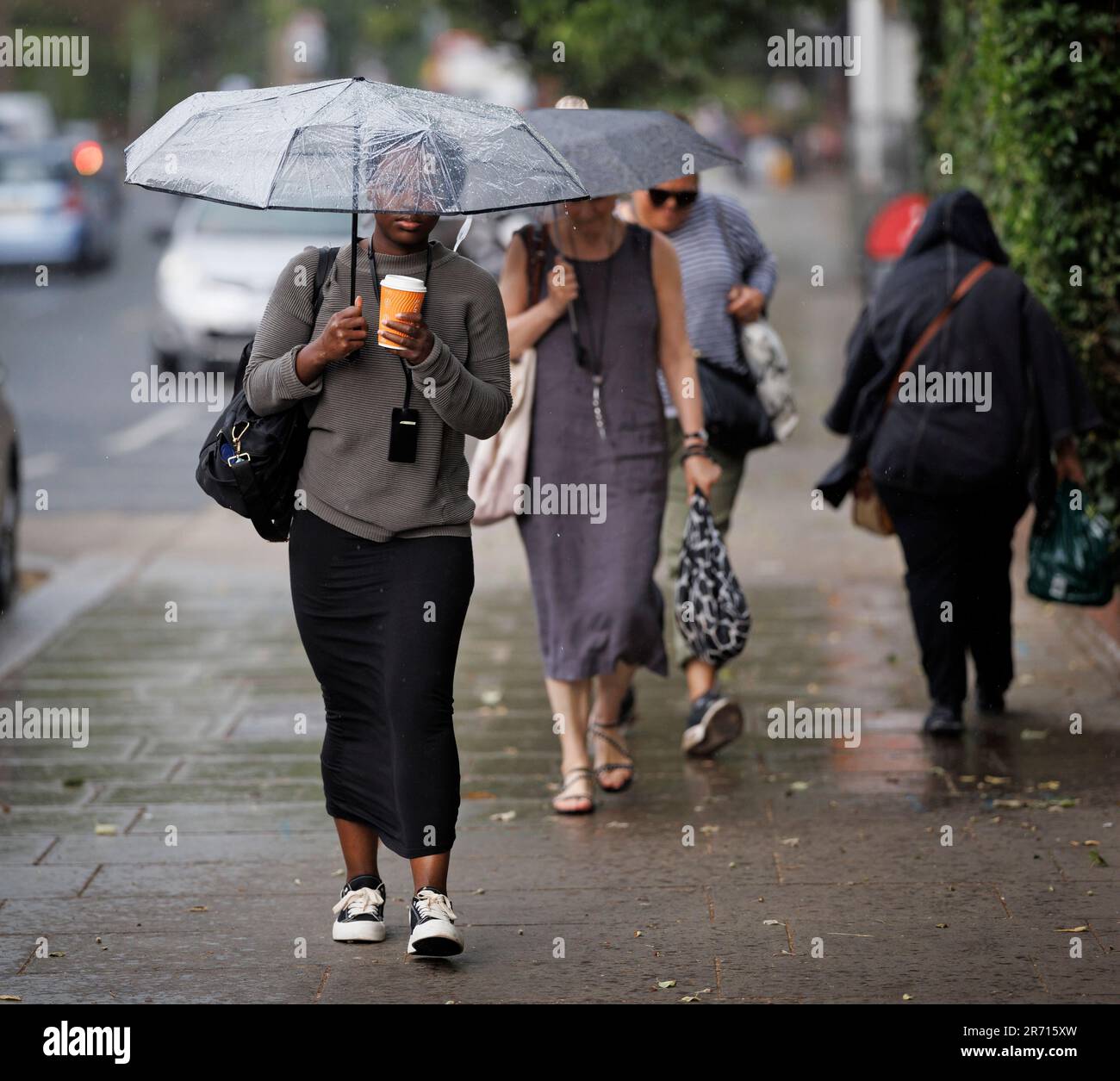 London, UK. 12th June, 2023. Members of the public get caught in a ...
