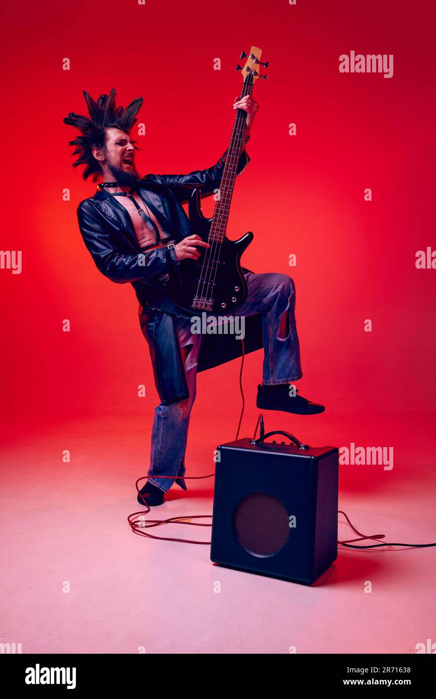 Rock musician. Young man, punk in extraordinary clothes and hairdo ...