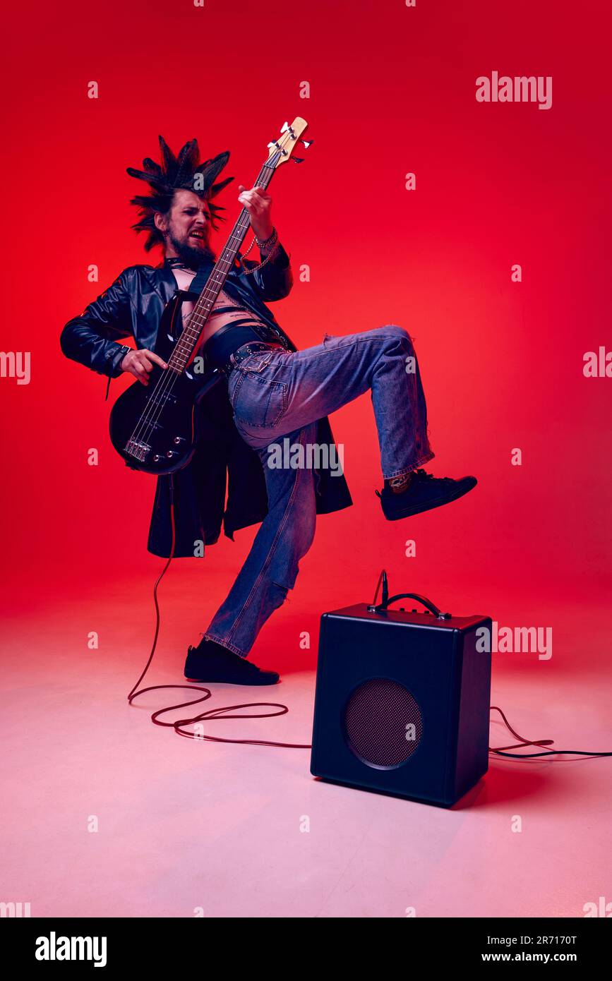 Rock and roll. Young man, punk in extraordinary clothes and hairdo ...