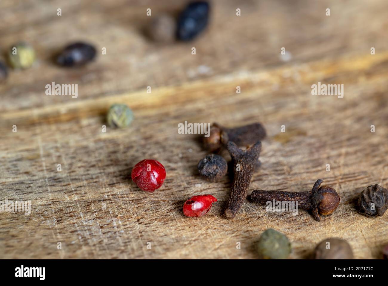 Different types of spices scattered on the table during cooking, using ...