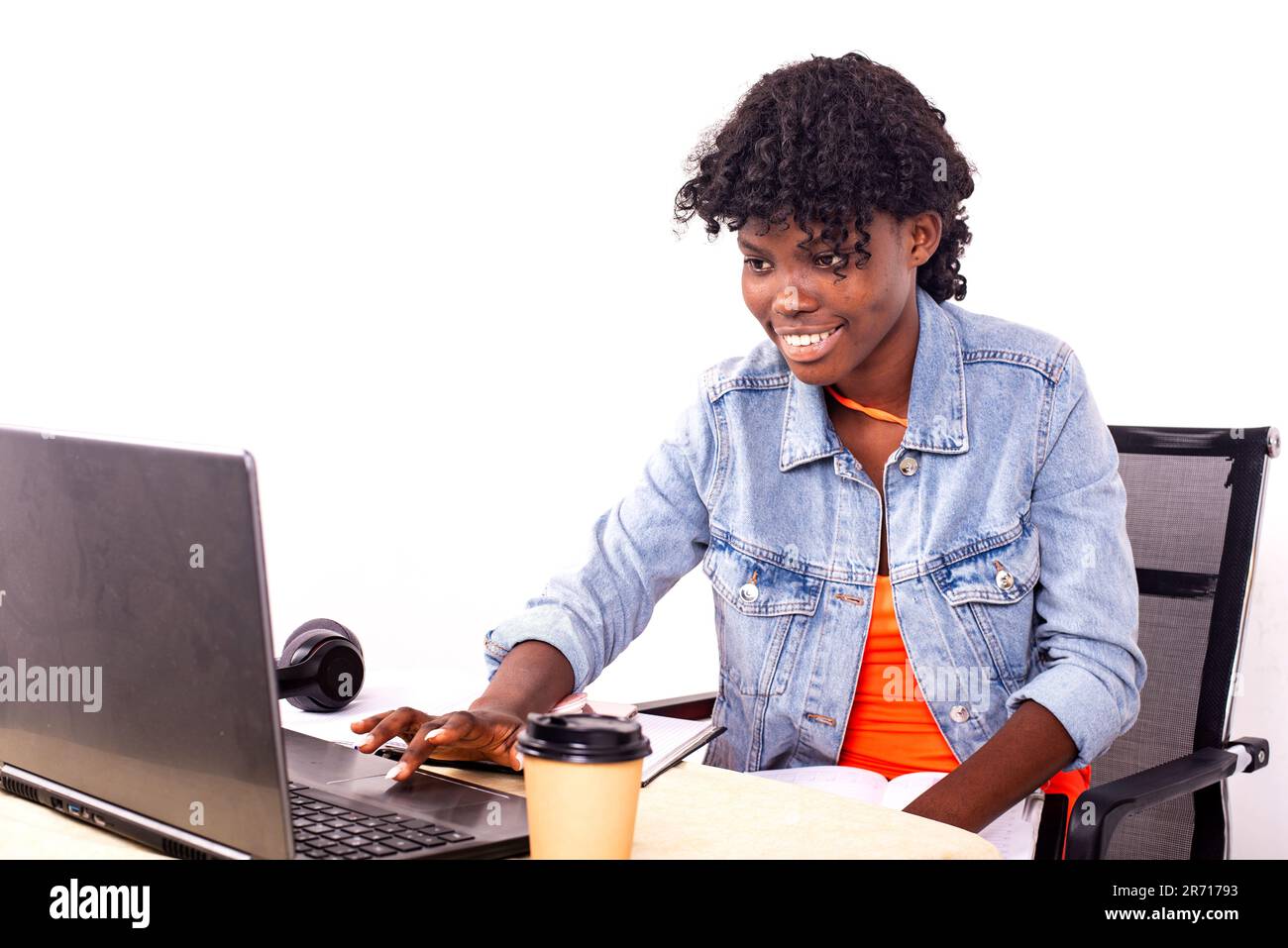 portrait of a beautiful young student girl studying with laptop ...