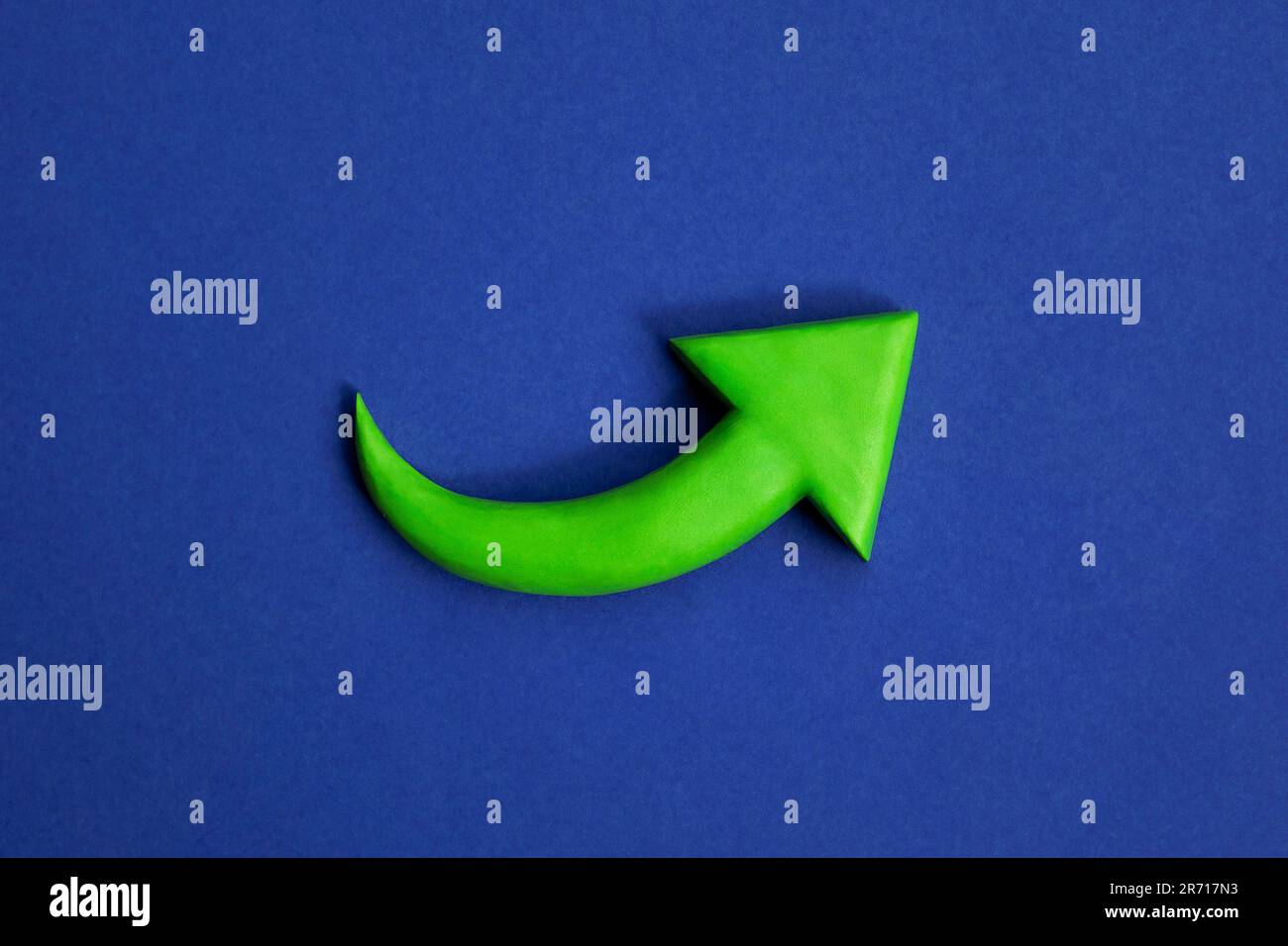 Vibrant green arrow pointing up. 3D mockup, plasticine arrow sign ...