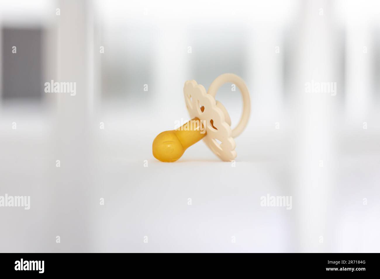 Baby's pacifier on a blurred white background Stock Photo - Alamy