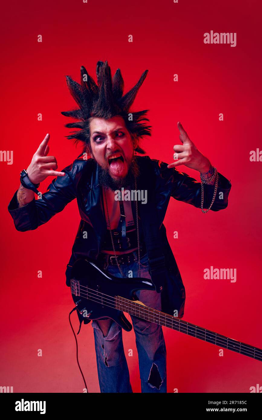 Aggressive impressive pose. Rok musician, man posing with hand gesture ...