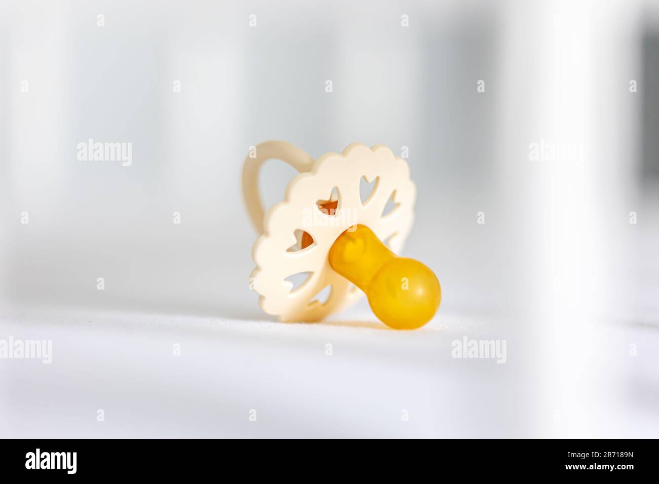 Baby's pacifier on a blurred white background Stock Photo - Alamy