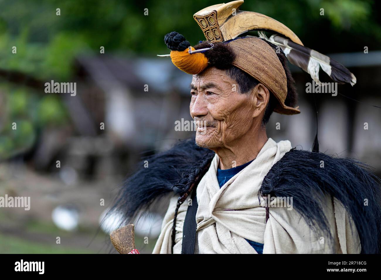 Portrait of a man Nyishi elder in his traditional tribal clothes with ...