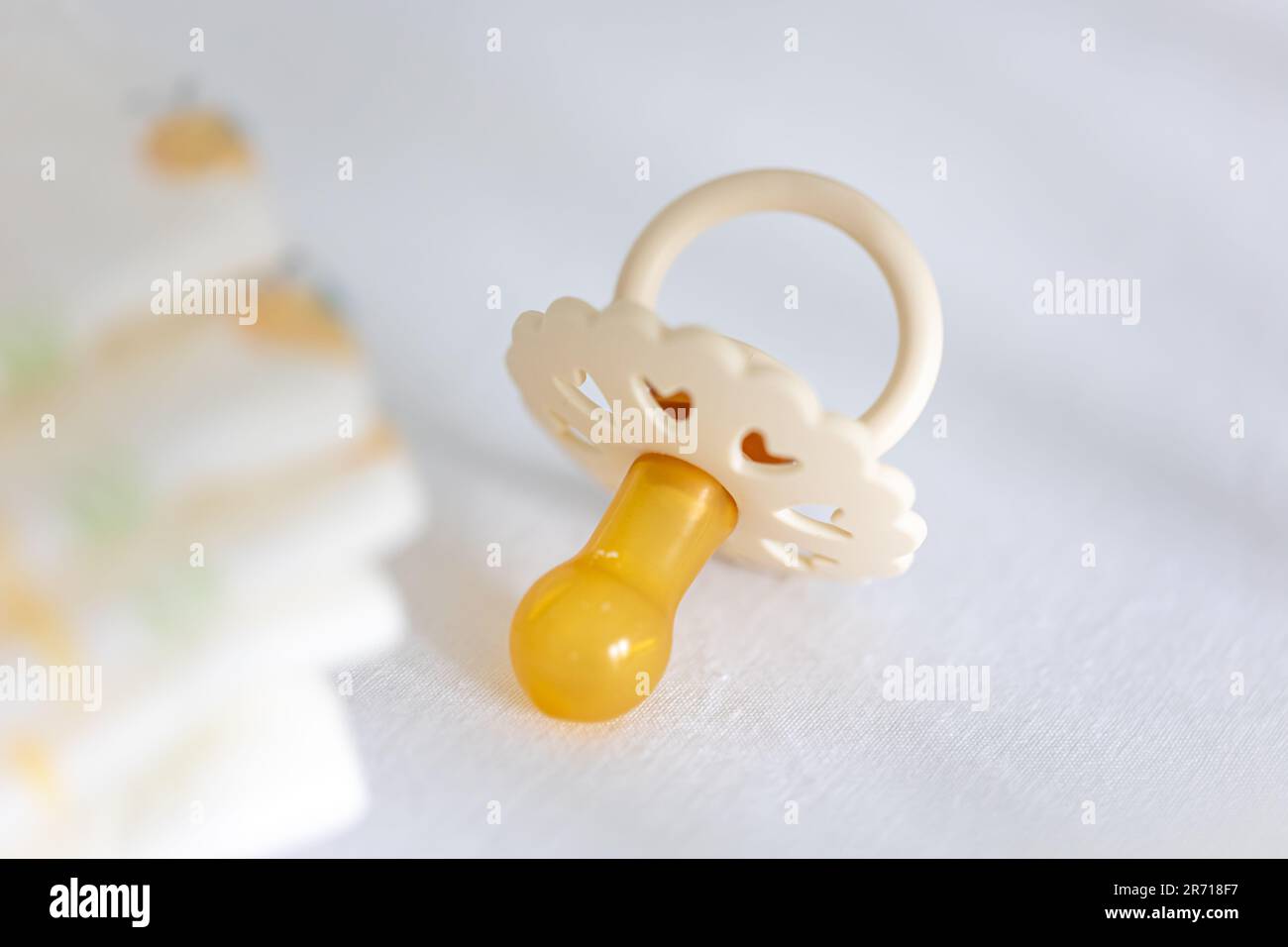 Baby's pacifier on a blurred white background Stock Photo - Alamy
