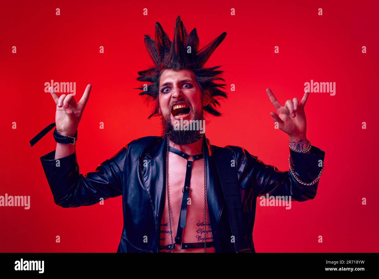 Aggressive impressive pose. Rok musician, man posing with hand gesture ...