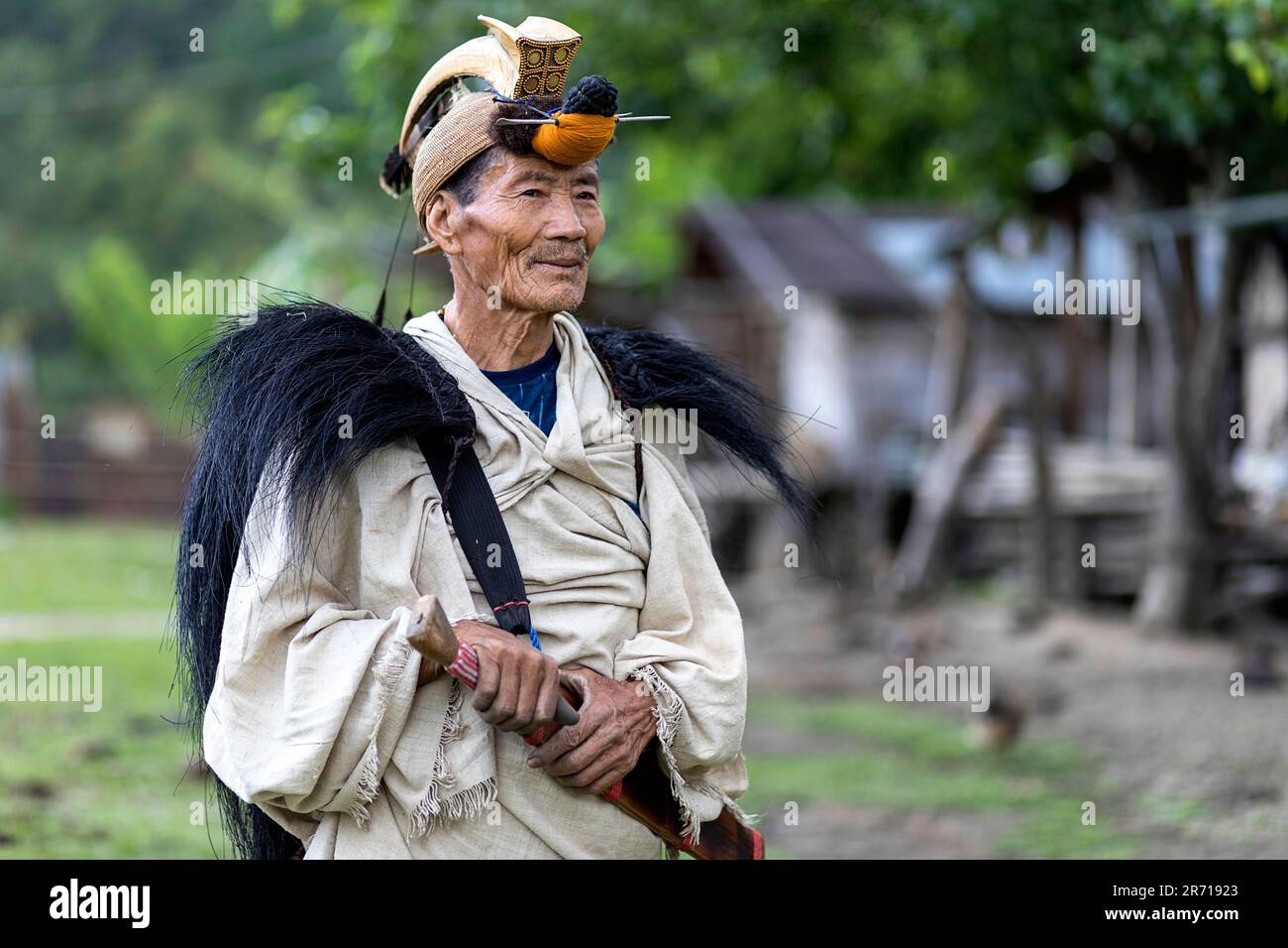 Portrait of a man Nyishi elder in his traditional tribal clothes with ...
