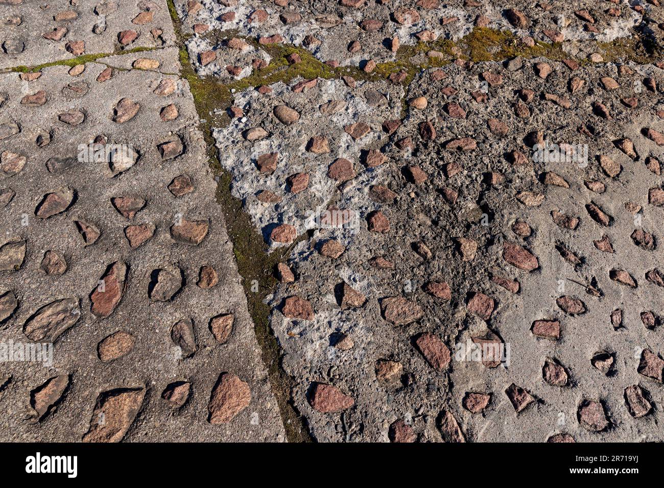 concrete walking path with natural stones, decorative road for walking ...