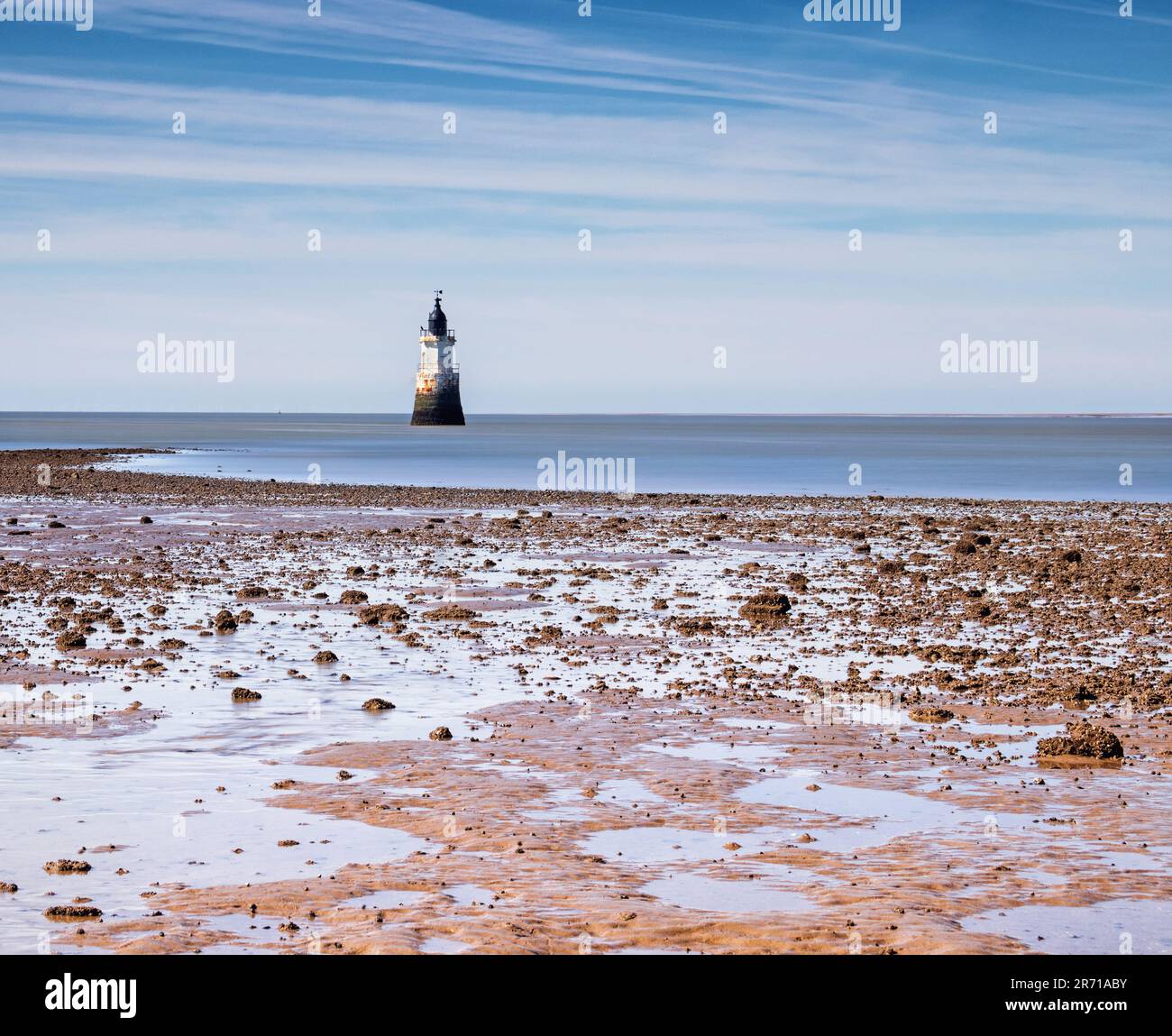The rocky beach near Plover Scar Lighthouse on Cockerham Sands, near ...