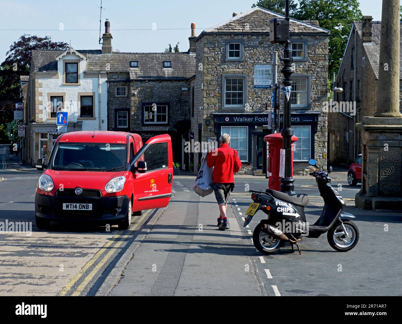 Postman collecting mail from post-box in Settle, North Yorkshire ...