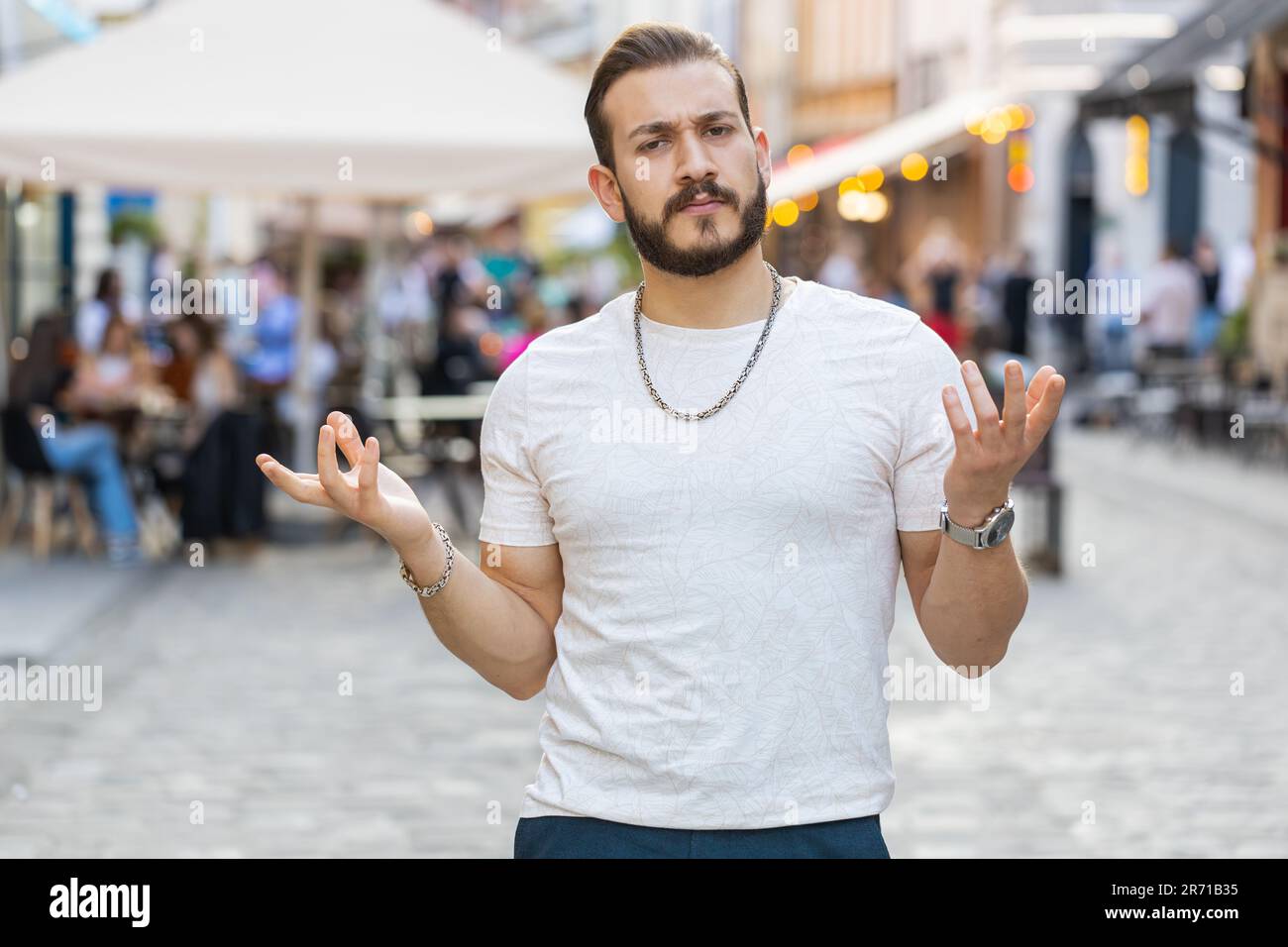 What. Why. Surprised frustrated bearded young man raising hands asking reason of failure ...