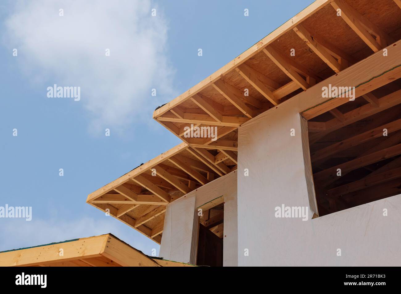 There are wooden beams rafters planks along corner of house that are ...