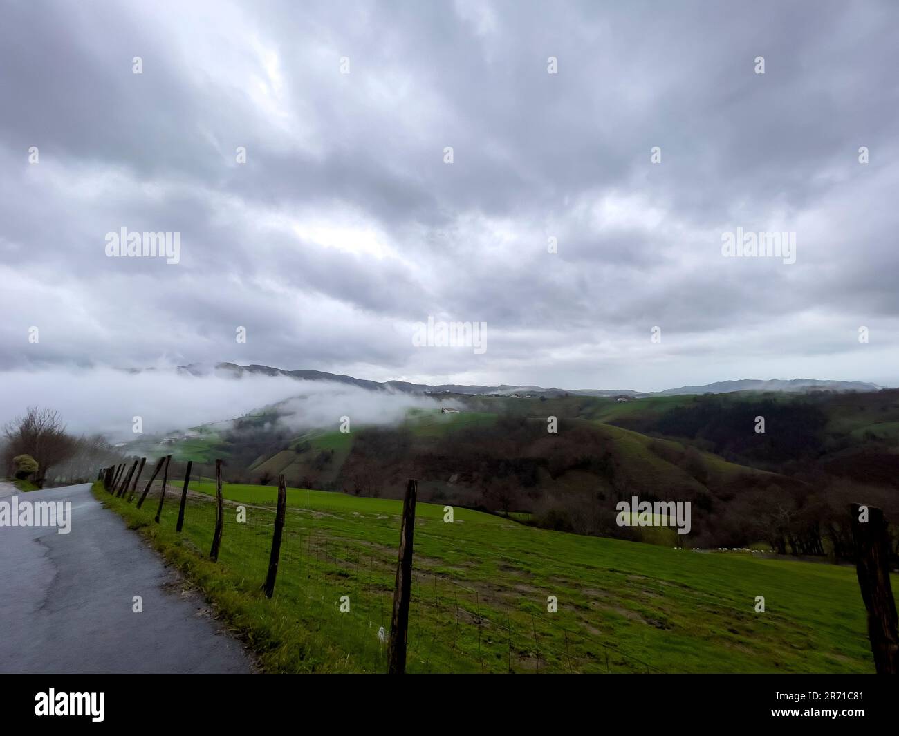 Mountains with fog and low clouds, pastures of Spanish Basque Country ...