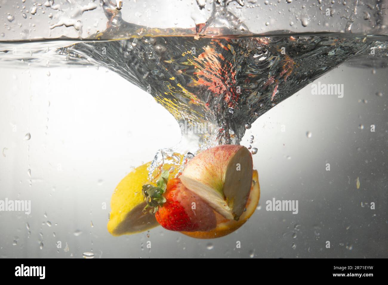 fruit being dropped into water Stock Photo - Alamy