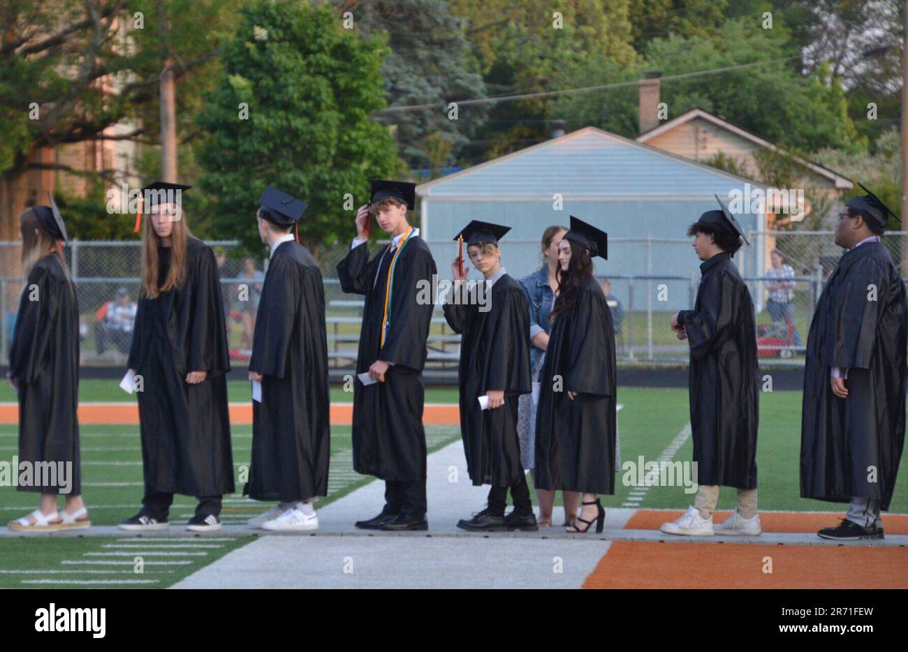 Soon-to-be graduates wait in line to receive their diplomas during La ...