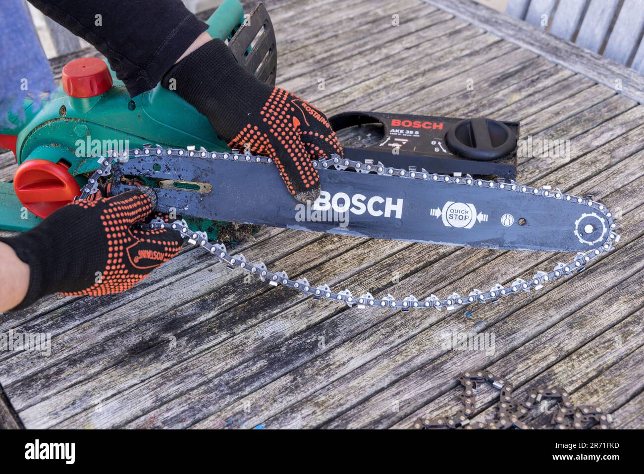 Changing the chain on an electric chainsaw Stock Photo - Alamy