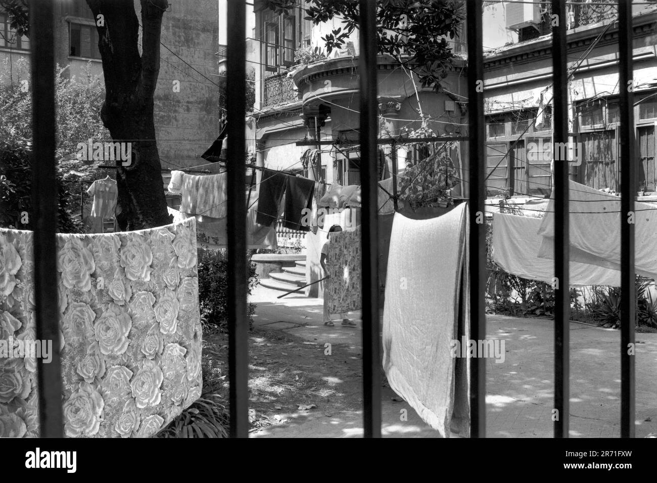 Public housing, Shanghai China woman hanging out family clothes wash to ...