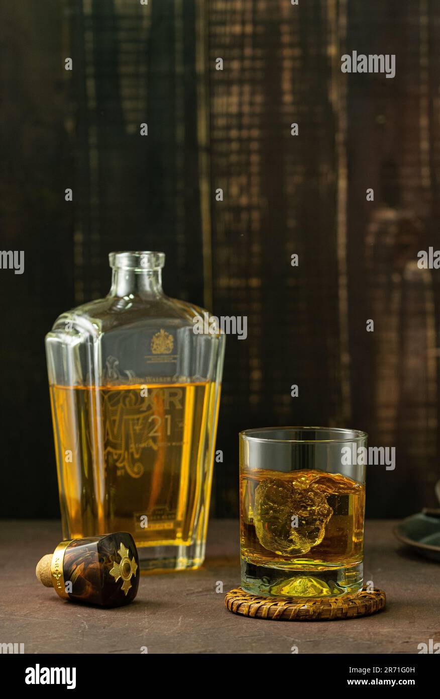 An array of alcoholic beverages in a bottle and a glass with a cork on ...