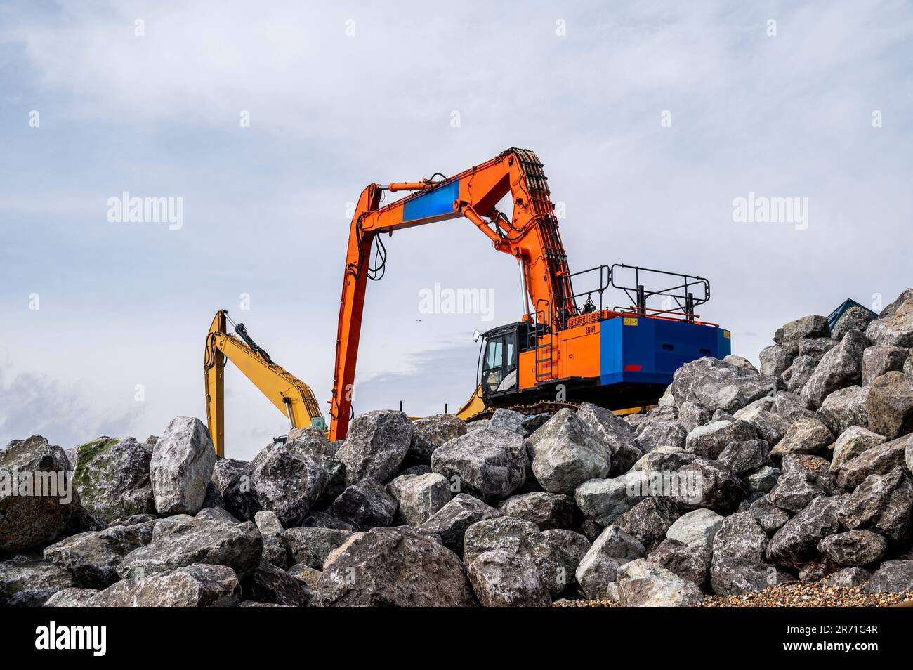 Mechanical excavator building the new shore defences against flooding ...