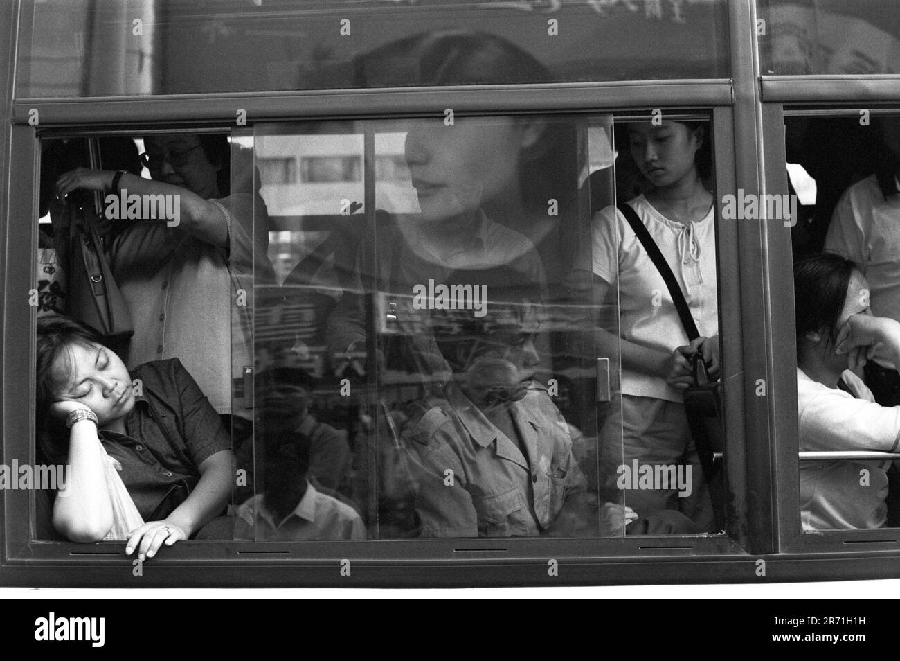 Shanghai China 2000. The bus home to the suburbs an office worker fast ...