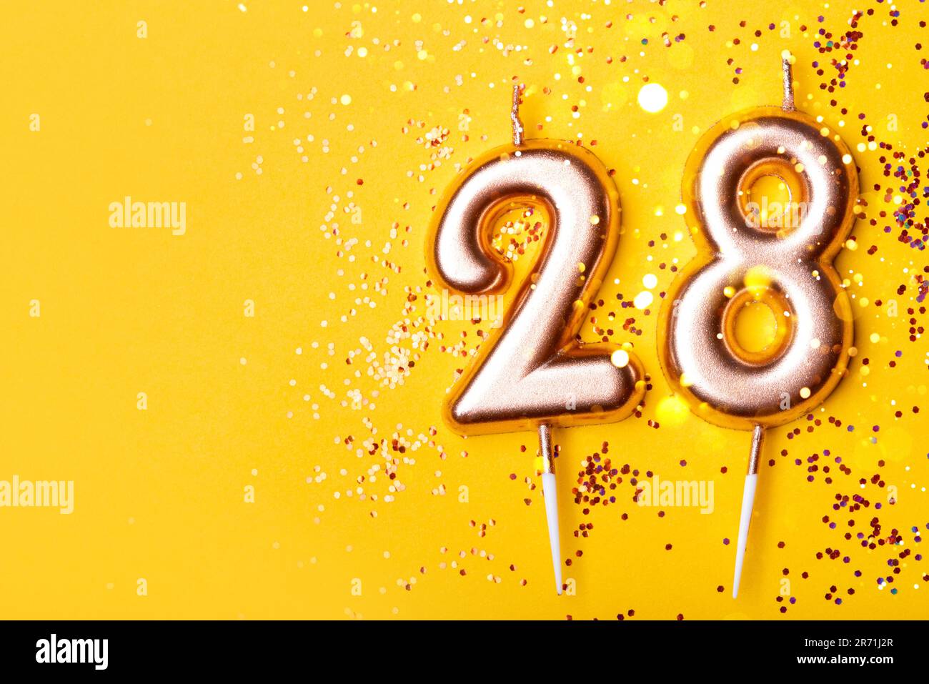 28 years celebration. Greeting banner. Gold candles in the form of ...