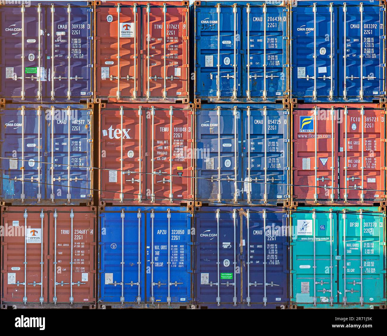 Backs of a bunch of colorful shipping containers in midday sun Stock ...