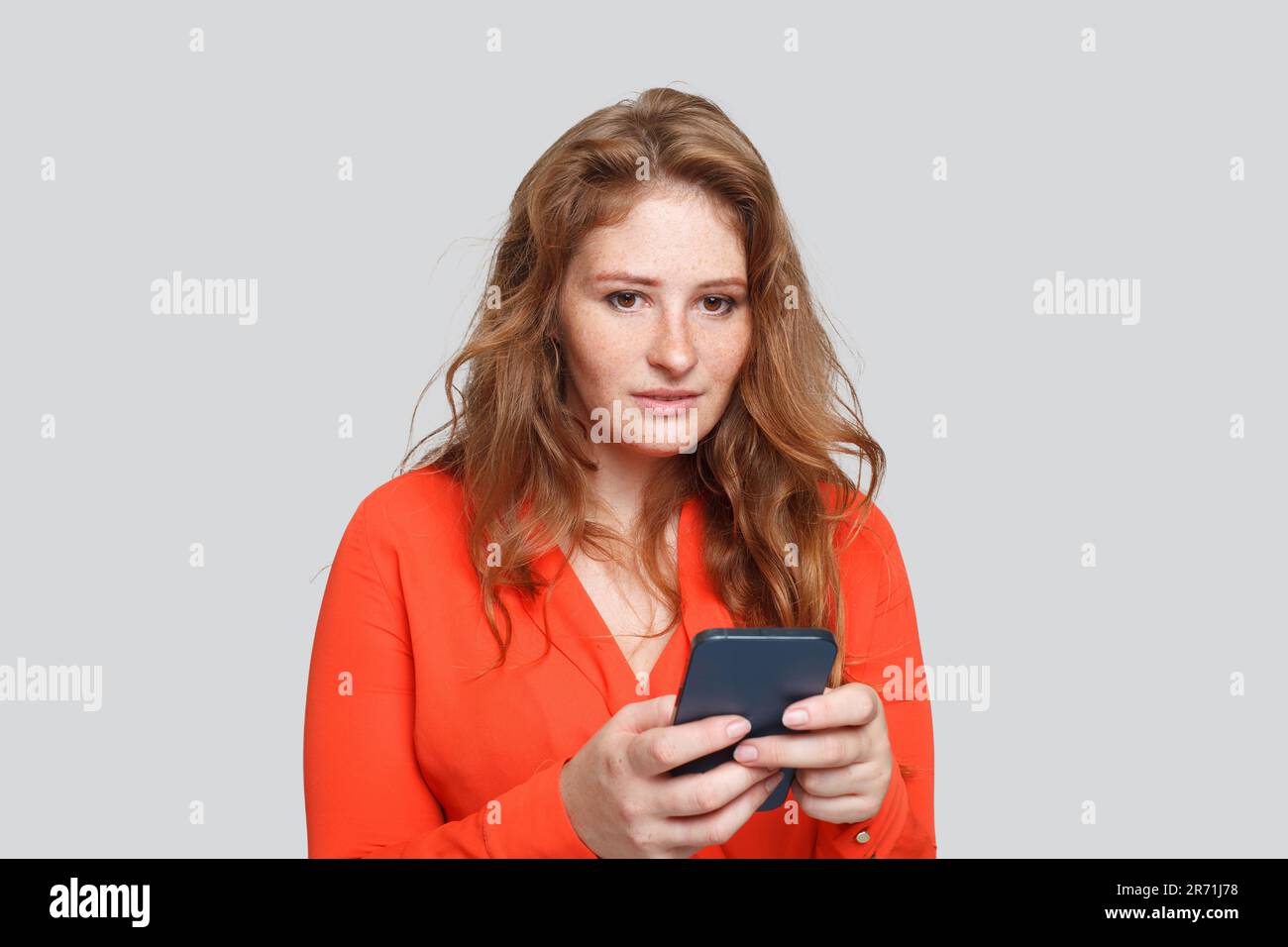 Attractive woman using app on her smartphone on white background Stock ...