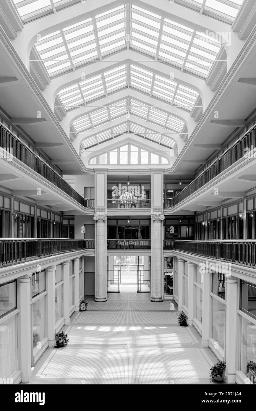 Turn of the century arcade building interior with sun streaming in ...